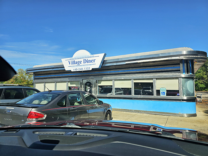 The classic chrome-and-blue exterior of Village Diner gleams like a time machine to the golden age of American breakfast. Pure roadside magic!
