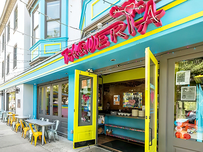The neon-pink "TAQUERIA" sign against turquoise and yellow isn't just a restaurant entrance&mdash;it's a mood-lifting color therapy session disguised as a dining destination.