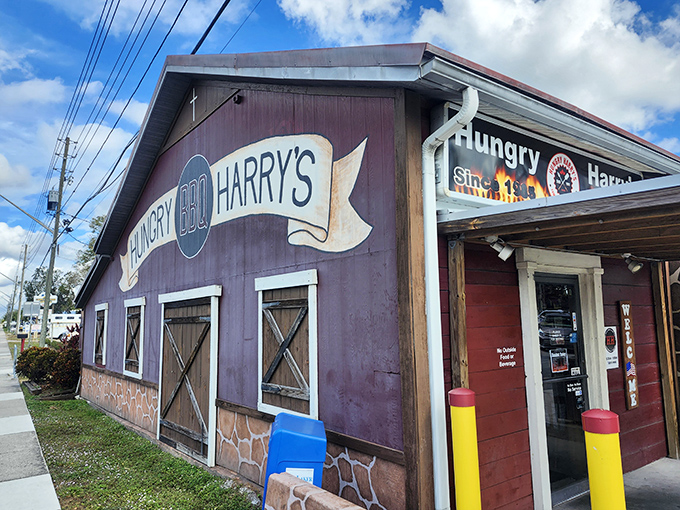 The purple barn-like exterior of Hungry Harry's stands as a beacon of BBQ authenticity. No fancy frills, just the promise of smoky deliciousness waiting inside.