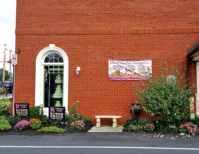 The brick exterior of The Pennsylvania Bakery welcomes you with an elegant arched window and colorful flower beds &ndash; like a storybook cottage where calories don't count.