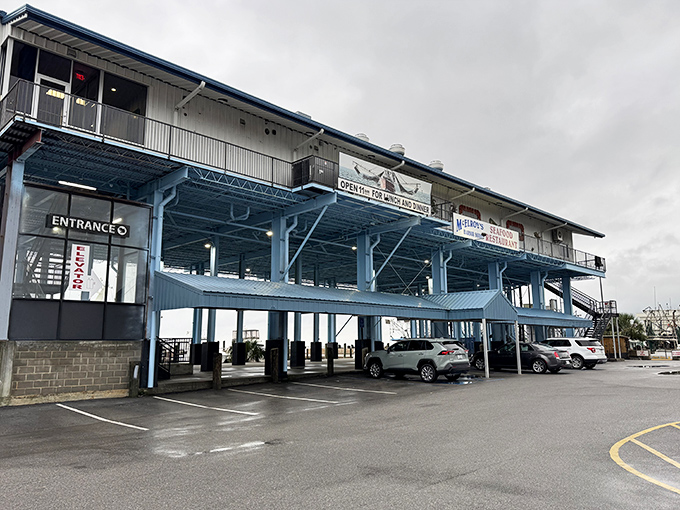 McElroy's stands like a coastal sentinel on stilts, inviting hungry travelers to climb up for seafood treasures that await above the parking lot.