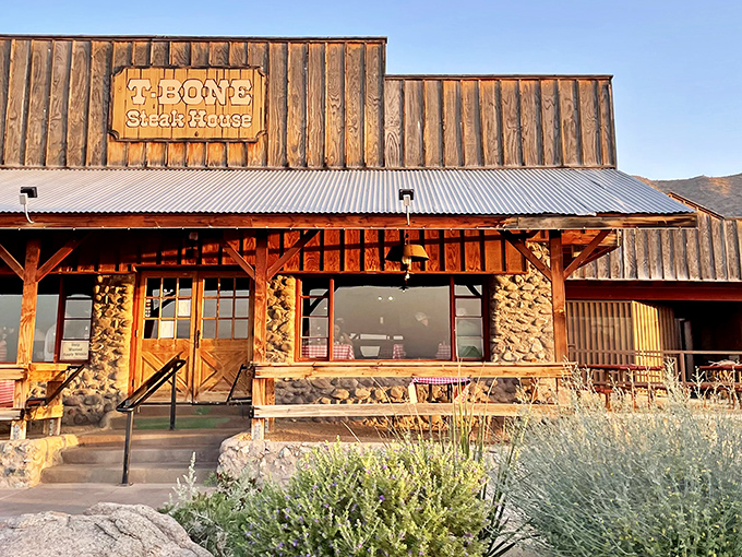 With its weathered wood and stone exterior, T-Bone Steak House rises against the Arizona sky like a rustic outpost for steak lovers.