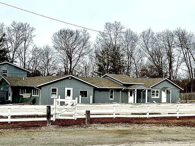 The unassuming blue exterior of Capricorn Inn stands quietly by the roadside, hiding culinary treasures within its modest walls.