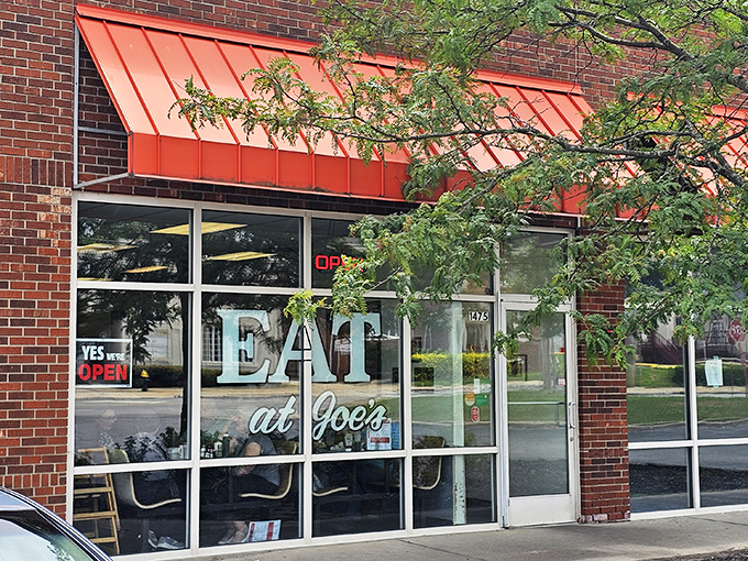 The unassuming storefront of Eat at Joe's in South Euclid&mdash;where that distinctive red awning signals legendary cheeseburgers await inside.