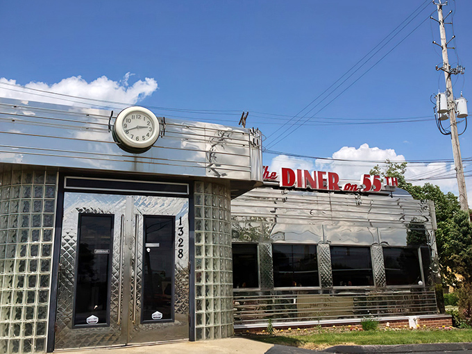 The gleaming stainless steel exterior of The Diner on 55th stands like a time capsule of Americana, complete with that iconic clock reminding you it's always time for breakfast.