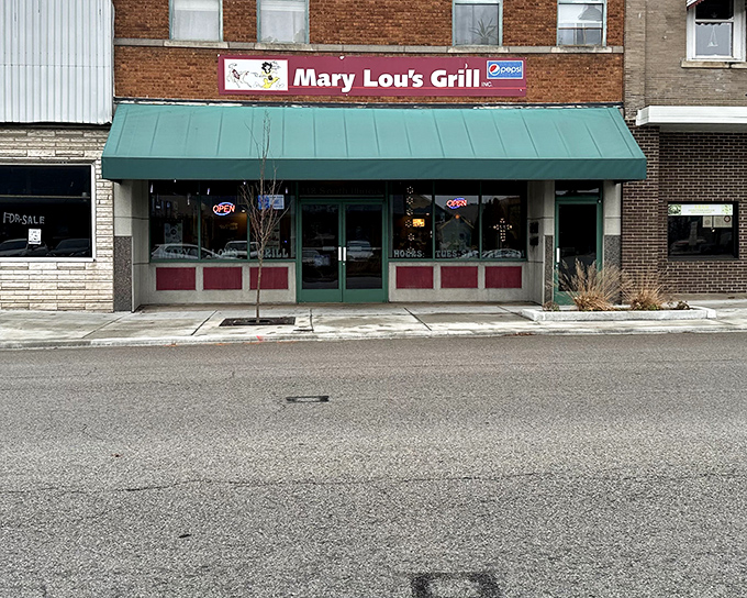 The unassuming storefront of Mary Lou's Grill doesn't scream "food paradise," but locals know better. That green awning signals breakfast nirvana awaits inside.