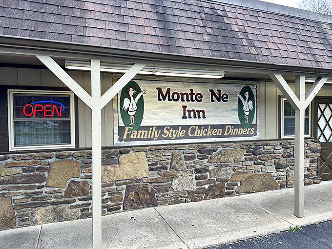 Vintage farm tools adorn walls above orange-clothed tables, creating a museum of rural Americana where the main exhibit is your soon-to-arrive feast.
