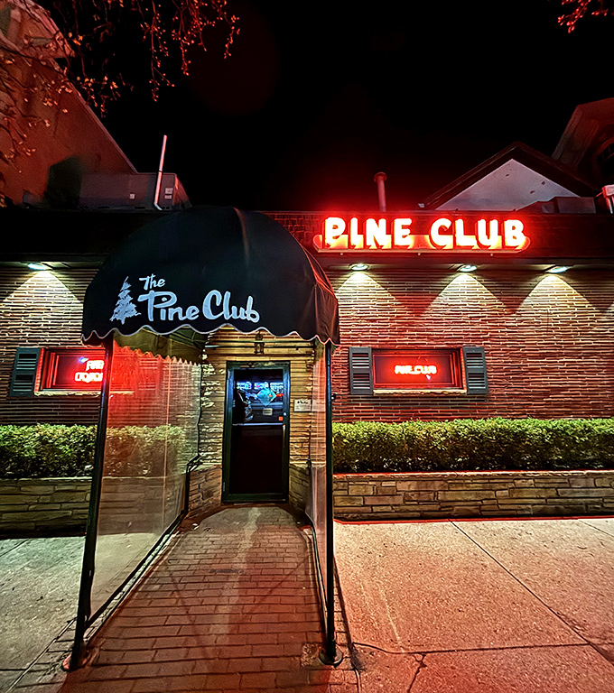 The Pine Club's iconic neon sign glows like a beacon in the night, promising carnivorous delights to hungry Daytonians seeking steak salvation.