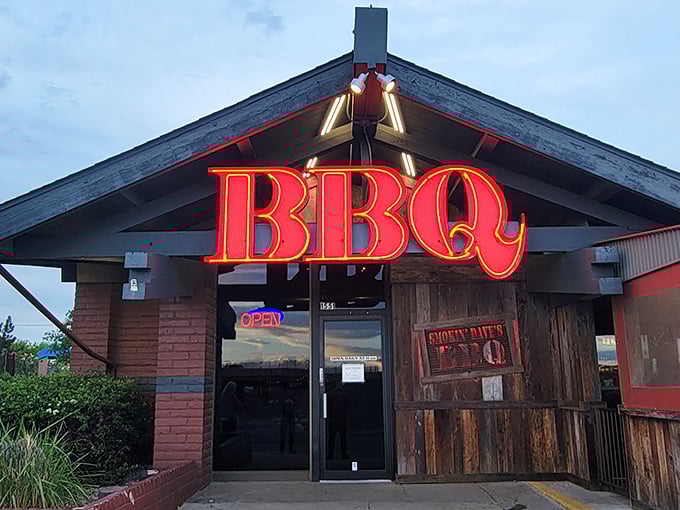 Morning light reveals the rustic charm of Smokin' Dave's, where that glowing BBQ sign has likely guided many a barbecue pilgrim to their meaty destiny.