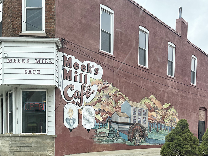 The unassuming exterior of Meek's Mill Cafe, with its charming mural, stands as a beacon for hungry travelers. Small-town Michigan at its most delicious.