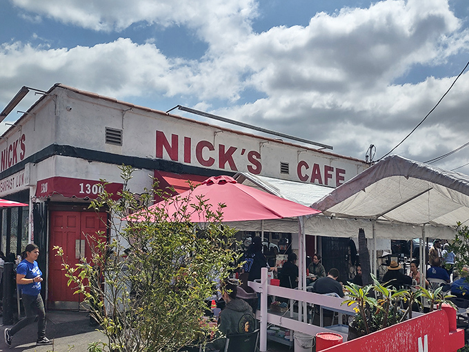 Weekend warriors gather under cheerful umbrellas outside Nick's, where the pink patio seating has witnessed more breakfast epiphanies than a Sunday sermon.
