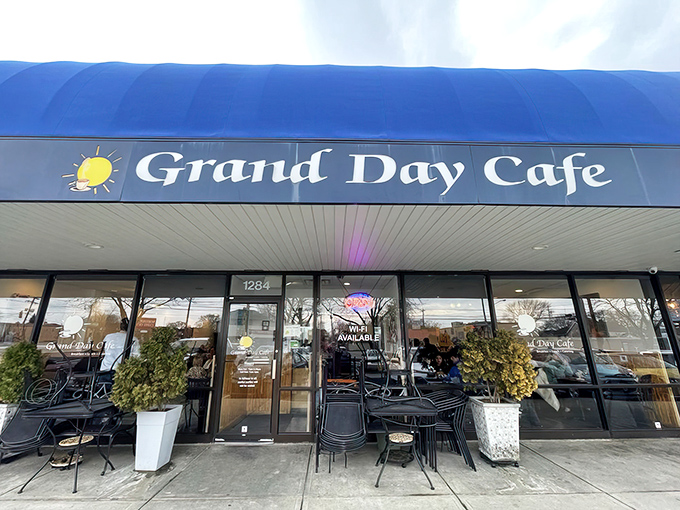 The iconic blue awning of Grand Day Cafe stands out like a beacon for breakfast lovers, promising comfort food that'll make your taste buds do a happy dance.