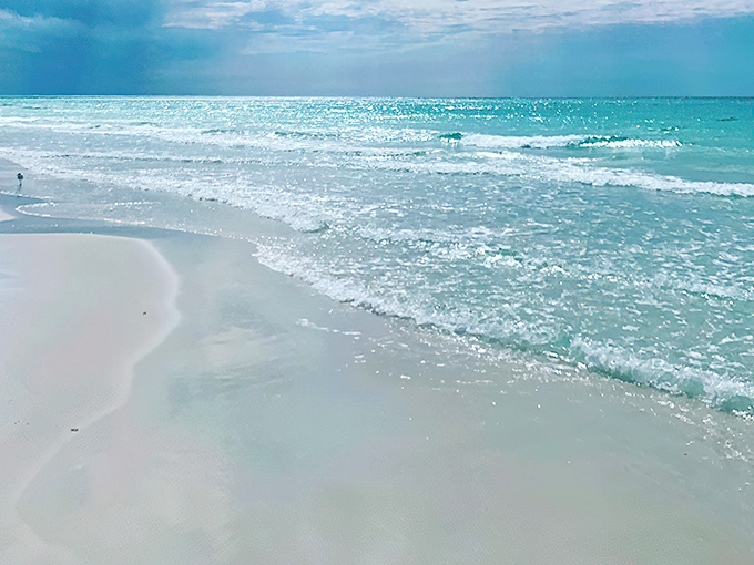 Mother Nature's watercolor masterpiece in action. The gentle turquoise waves of Opal Beach kiss shores so white they'd make a dentist jealous.