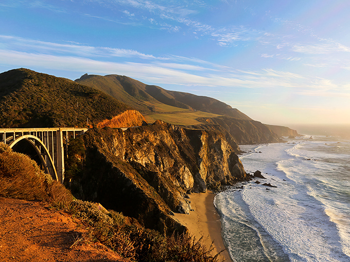 Bixby Creek Bridge stands like nature's perfect picture frame, where engineering brilliance meets California's wild beauty in golden afternoon light.