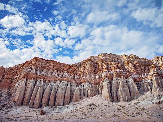 Nature's own cathedral rises from the desert floor, with columns that would make any architect jealous. The sky's just showing off at this point.