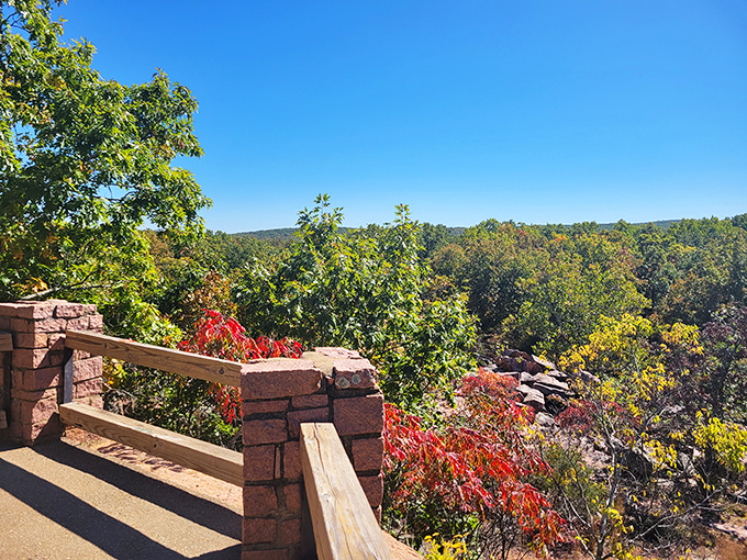A stunning overlook at Elephant Rocks State Park reveals a canopy of fall colors stretching endlessly under the bright Missouri sky.