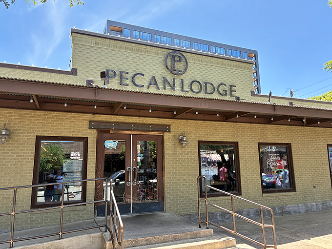 The yellow brick exterior of Pecan Lodge stands like a temple to Texas BBQ, beckoning hungry pilgrims to its smoky sanctuary in Deep Ellum.