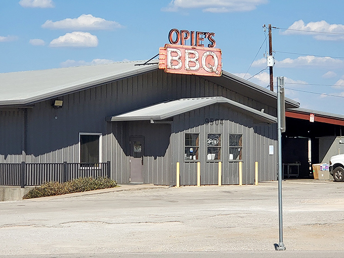That iconic orange sign against the Texas sky is like a beacon for hungry travelers. Trucks in the parking lot? Always a good sign at a BBQ joint.