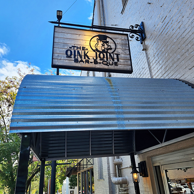 That wooden sign with its dapper pig mascot promises what lies within &ndash; barbecue worth writing home about, if you can pause between bites.