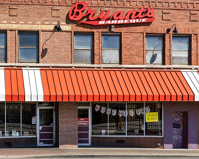The iconic red and white awning of Arthur Bryant's stands as a beacon of barbecue excellence in Kansas City's historic district.