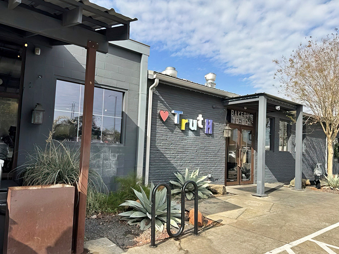 Truth's gray exterior with its colorful lettering doesn't scream "barbecue royalty," but that's Texas for you&mdash;the best spots often hide in plain sight.