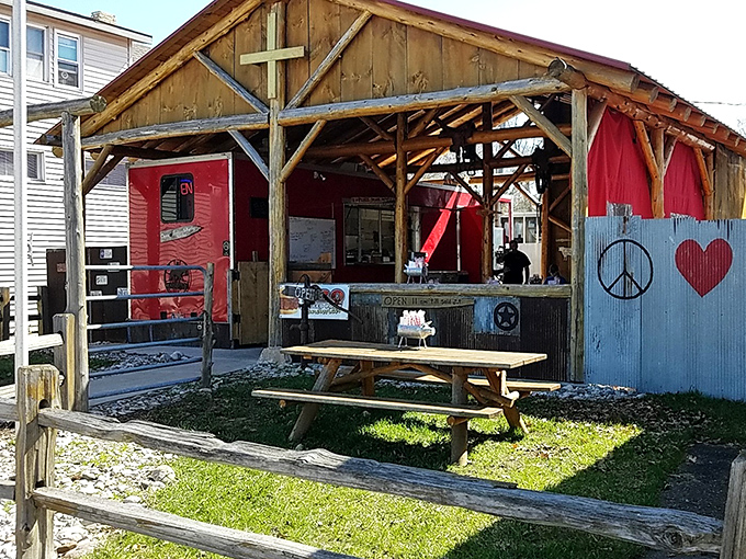 Rustic charm meets smoky perfection at this unassuming outdoor BBQ haven where peace, love, and brisket reign supreme.