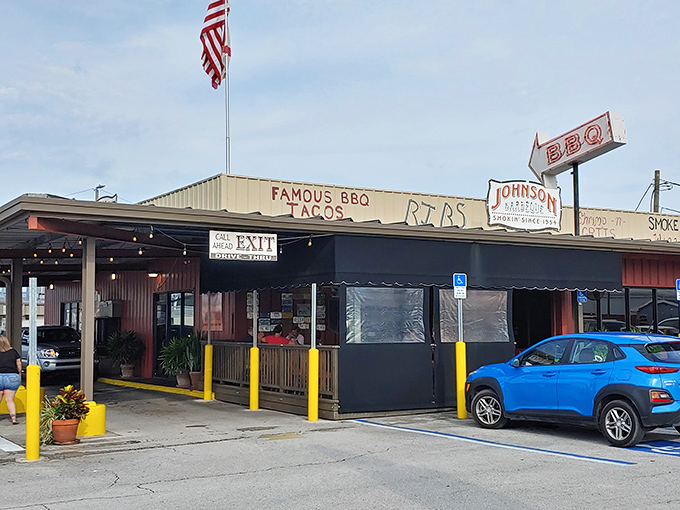 The humble exterior of Johnson Barbeque belies the flavor explosion waiting inside. That American flag isn't just patriotic&mdash;it's a beacon for BBQ pilgrims.