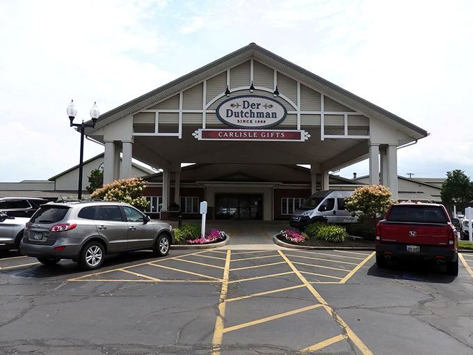 Der Dutchman's welcoming entrance stands like a culinary lighthouse, beckoning hungry travelers with promises of Amish comfort food that'll make your cardiologist wince and your soul sing.
