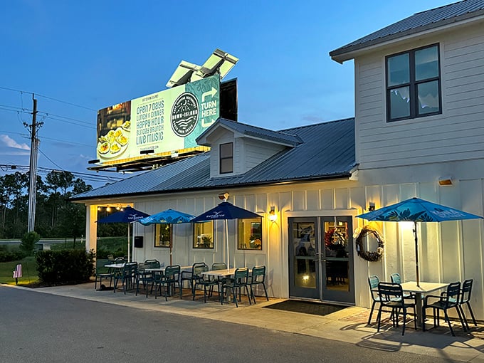 The coastal charm of Down Island glows at twilight, with blue umbrellas inviting you to linger outside before the seafood magic begins inside.