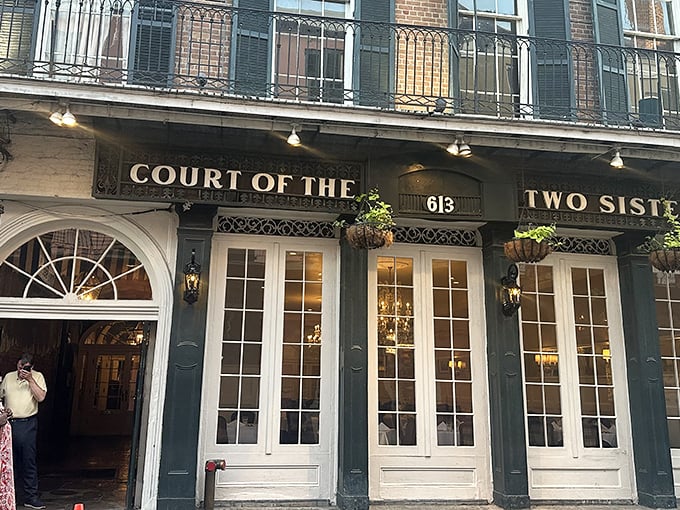 The iconic green fa&ccedil;ade of Court of Two Sisters beckons from Royal Street like a culinary siren song, promising centuries of Creole magic within.