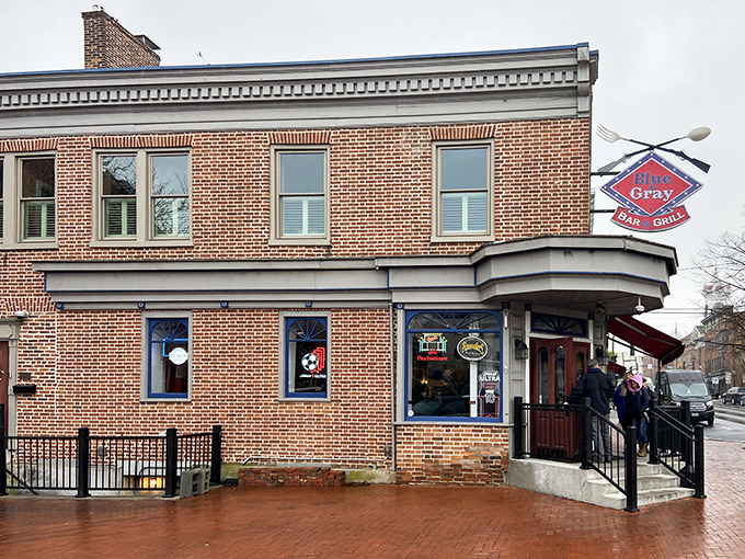 The historic brick exterior of Blue & Gray Bar & Grill stands as a delicious beacon in downtown Gettysburg, where history and hunger happily collide.