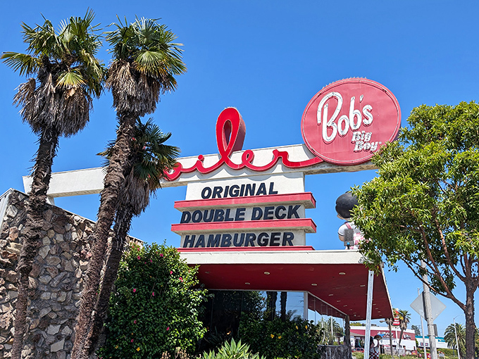 That iconic Bob's Big Boy sign against the California blue sky isn't just a restaurant marker&mdash;it's a beacon of burger bliss calling you home.