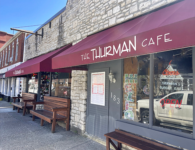 The unassuming storefront of The Thurman Cafe, where culinary legends are born behind that burgundy awning and limestone facade.