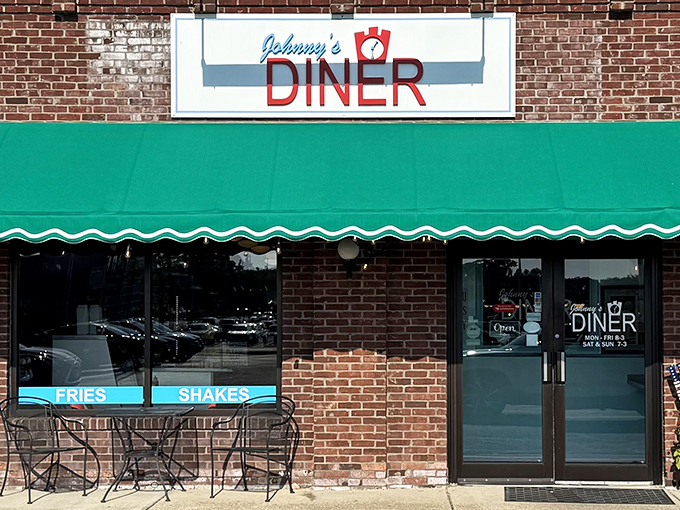 Johnny's Diner welcomes hungry travelers with its classic brick exterior and cheerful green awning &ndash; a beacon of breakfast hope on Hudson's main drag.