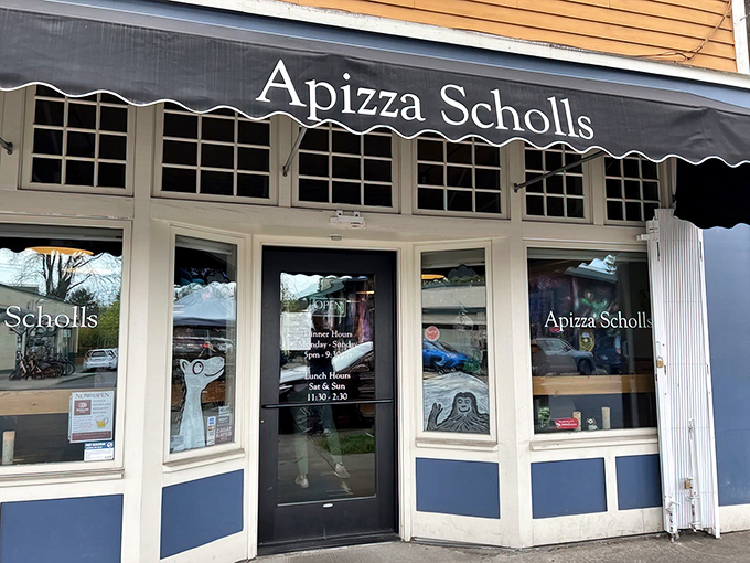 The unassuming storefront of Apizza Scholls beckons pizza pilgrims with its simple awning and promise of transcendent pies within.