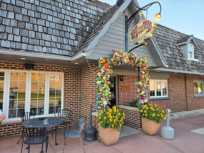 The iconic Schwarz's exterior welcomes you with its distinctive cedar shake roof and floral arch&mdash;Wisconsin hospitality in architectural form.