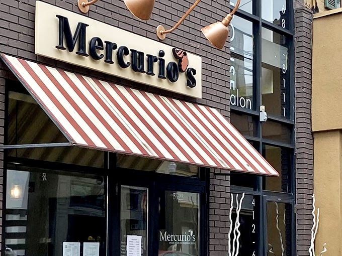The iconic red and white striped awning of Mercurio's beckons like a culinary lighthouse on Walnut Street, promising authentic Italian delights within.