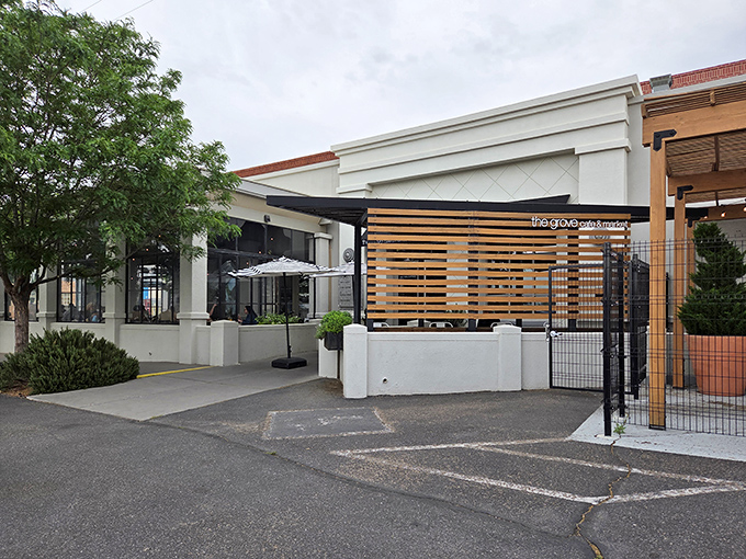 The Grove's clean white exterior and wooden accents create an oasis of calm in bustling Albuquerque. Modern design meets neighborhood charm.