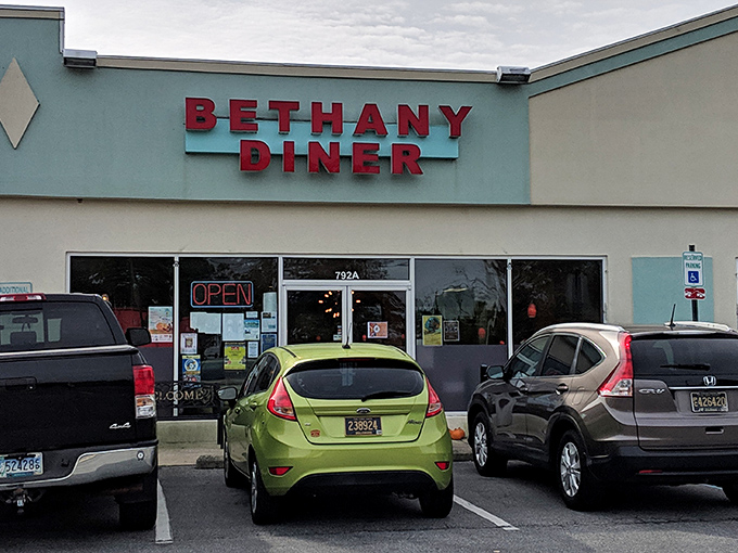 Morning sunshine illuminates the iconic red Bethany Diner sign, beckoning breakfast enthusiasts with the promise of coastal comfort food worth waking up for.