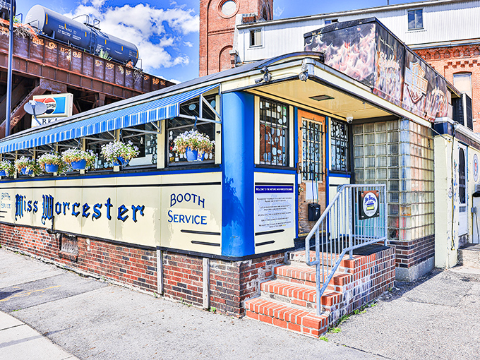 Sunlight bathes the vintage dining car's exterior, highlighting its classic "BOOTH SERVICE" lettering—architectural proof that breakfast traditions endure while cities transform around them.