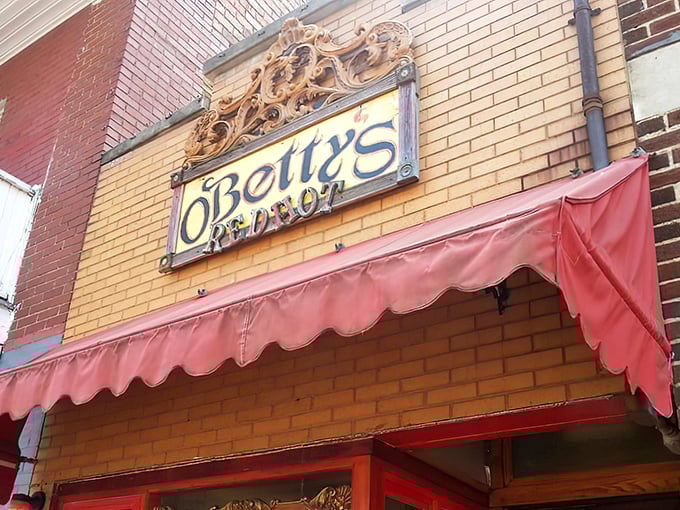 The iconic O'Betty's Red Hot storefront in Athens, with its vintage sign and welcoming red awning beckoning hot dog aficionados from near and far.