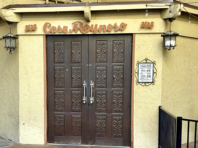 The ornate wooden doors of Casa Reynoso stand like sentinels guarding culinary treasures within. Desert elegance meets homestyle cooking behind these carved portals.