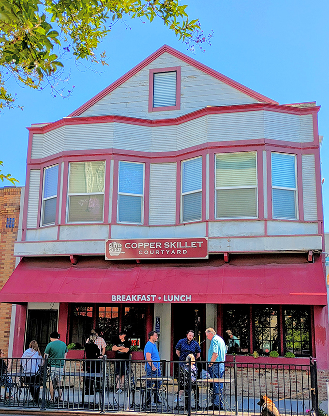 The Victorian charm of Copper Skillet Courtyard beckons with its distinctive red trim and welcoming awning&mdash;breakfast paradise hiding in plain sight on Ferry Street.