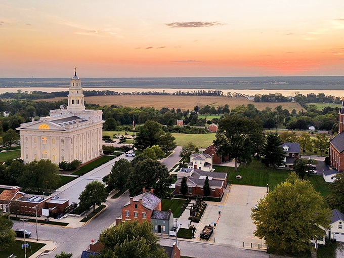Sunset transforms Nauvoo into a painting you'd swear was Photoshopped. The temple glows like a beacon while the Mississippi River stretches toward the horizon like nature's own highway.