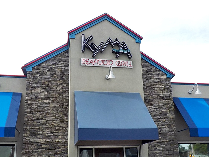 The iconic Kyma Seafood Grill exterior in Stevens, featuring a blue awning, hints at the delicious seafood experiences inside.