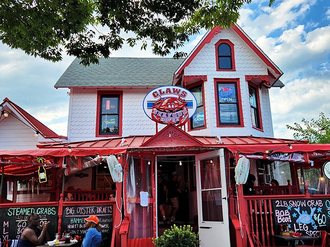 The white house with red trim stands like a seafood lighthouse on Rehoboth Avenue, beckoning hungry travelers with its unmistakable crab sign and promise of ocean treasures within.