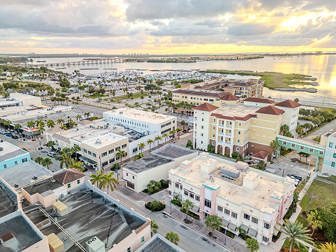 Sunset paints Fort Pierce in golden hues, where waterfront buildings and marina views create a postcard-perfect scene that whispers "affordable paradise."