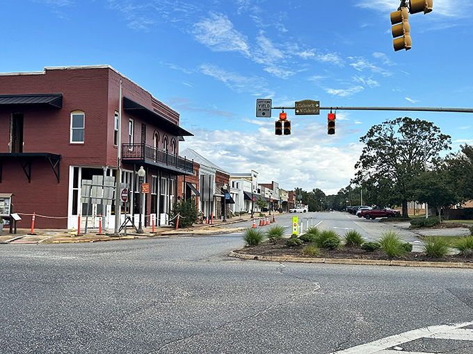 Downtown Monroeville at golden hour, where the historic courthouse dome watches over brick storefronts that haven't changed their prices much either.