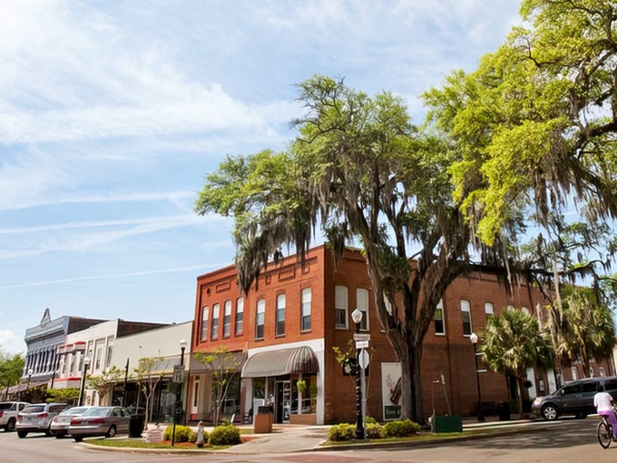 Historic brick storefronts shaded by moss-draped oaks whisper of old Florida, where time lingers and charm never left.