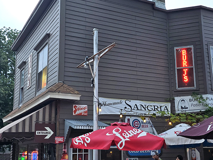 Daylight reveals Burt's modest facade, where the vertical sign and striped awning have guided hungry Chicagoans for decades.